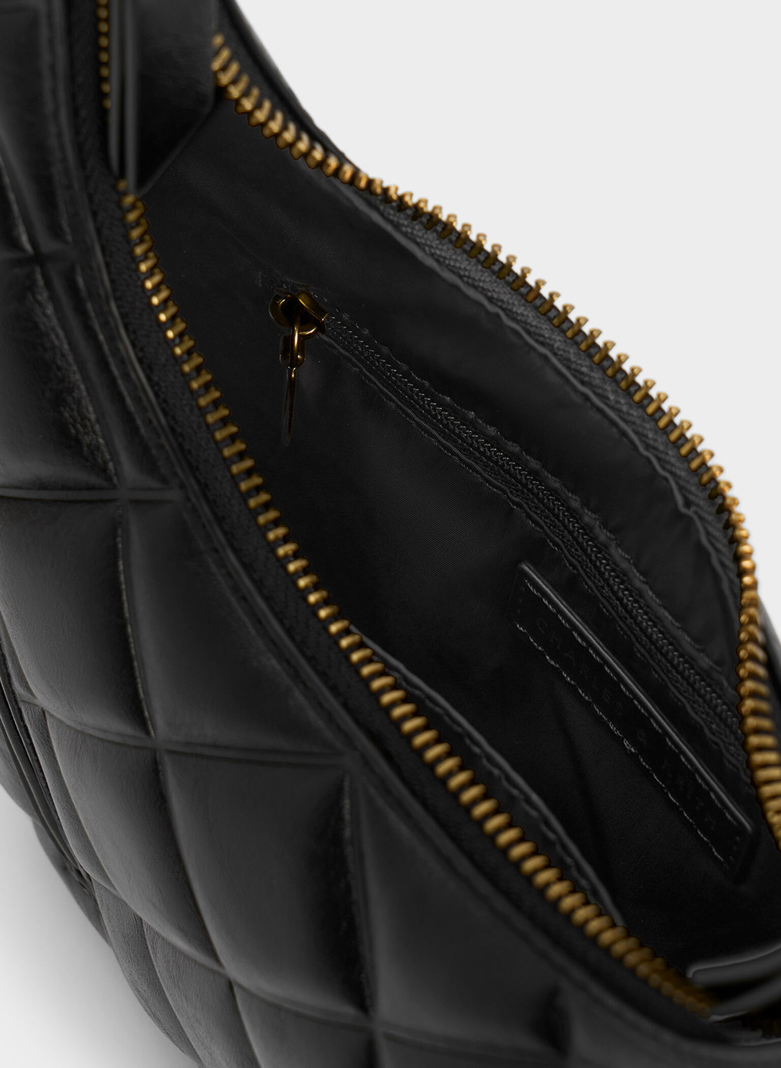 Black Swing Padlock Quilted Crescent Bag Charles And Keith Om